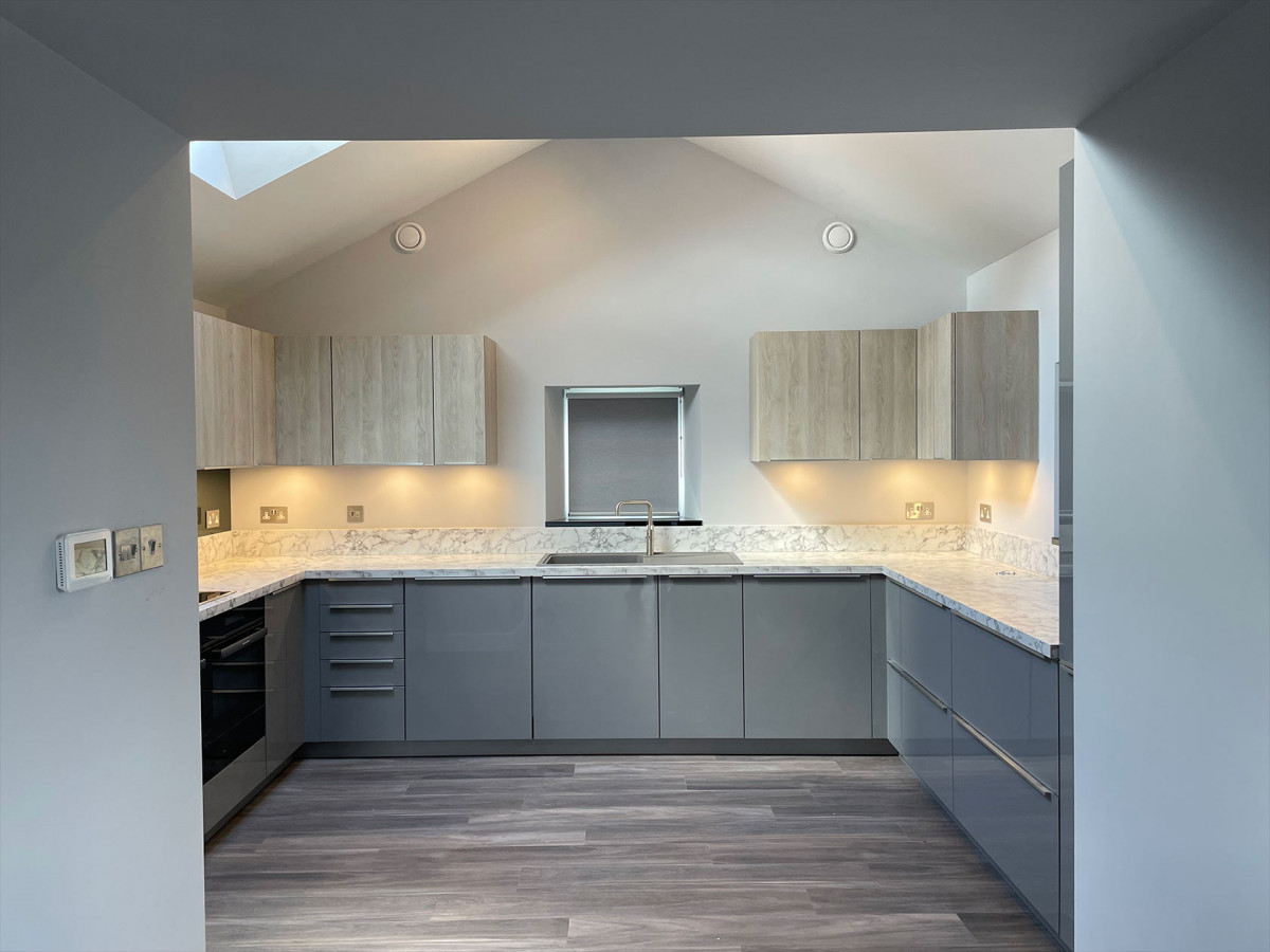 Contemporary German Handleless Kitchen in Soft Grey - Danby Interiors