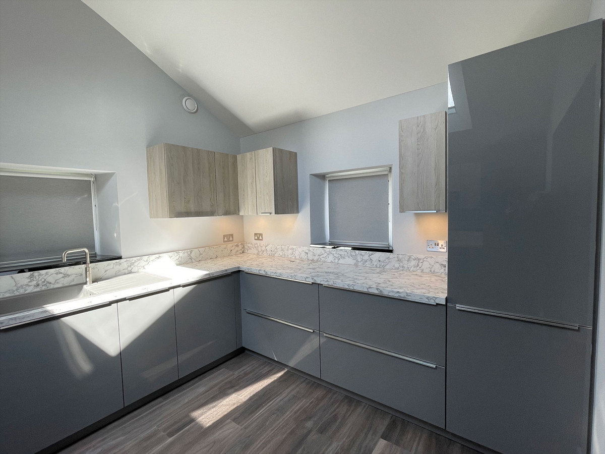 Contemporary German Handleless Kitchen in Soft Grey - Danby Interiors