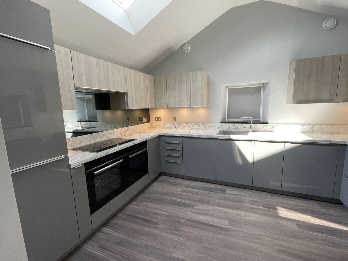 Contemporary German Handleless Kitchen in Soft Grey - Danby Interiors